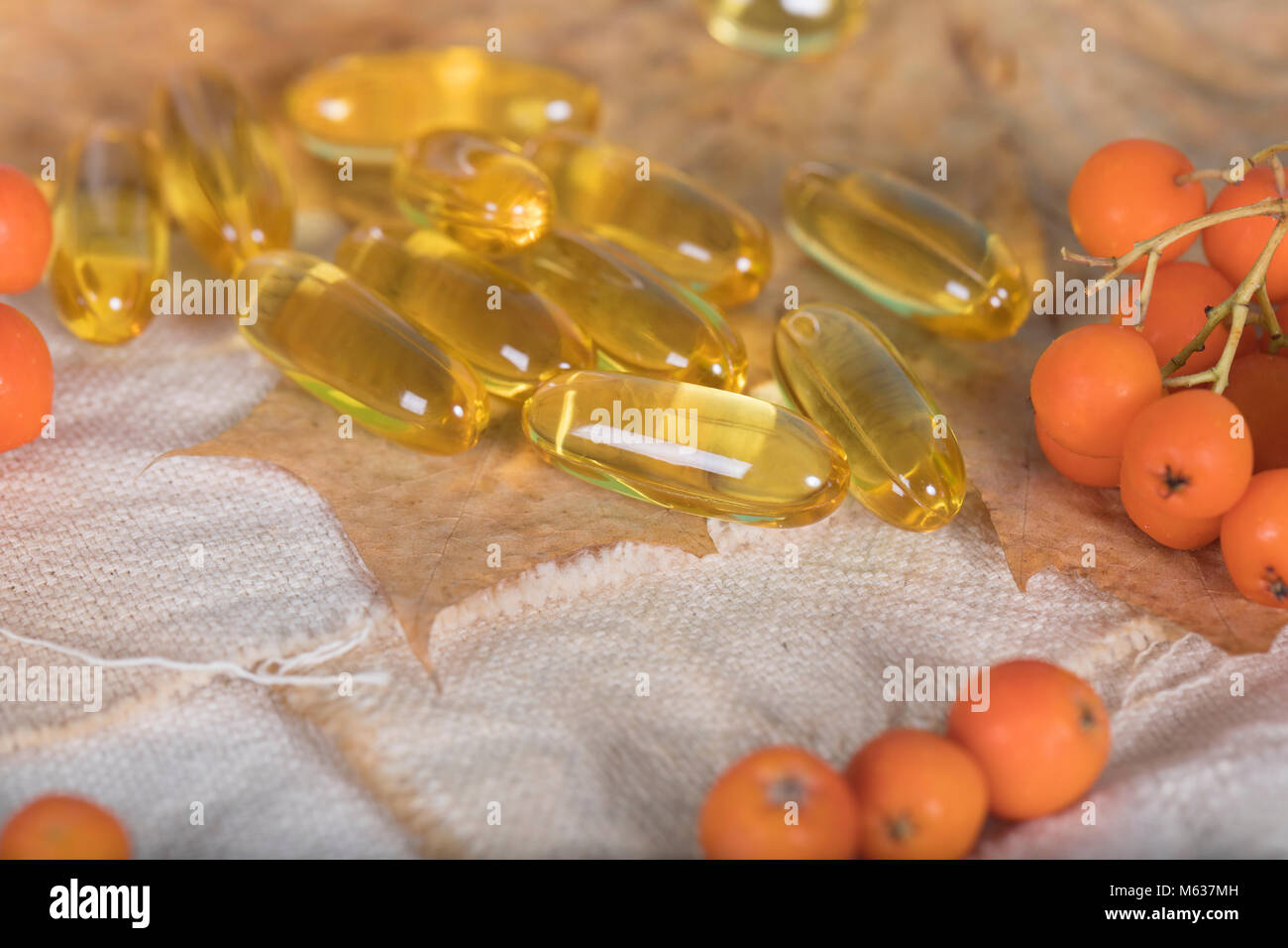 Softgels with rowan berries oil. Closeup Stock Photo - Alamy