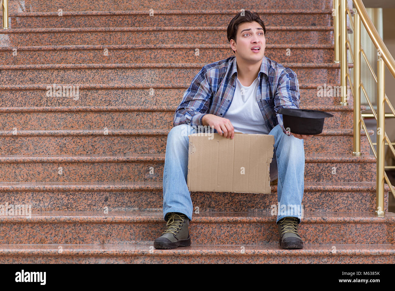 Young man begging money on the street Stock Photo - Alamy