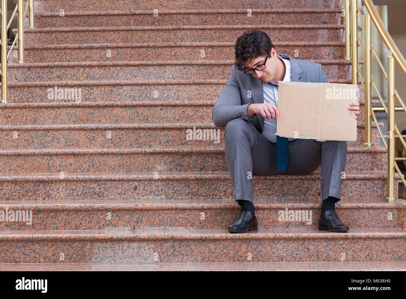 Desperate businessman begging on the street Stock Photo - Alamy