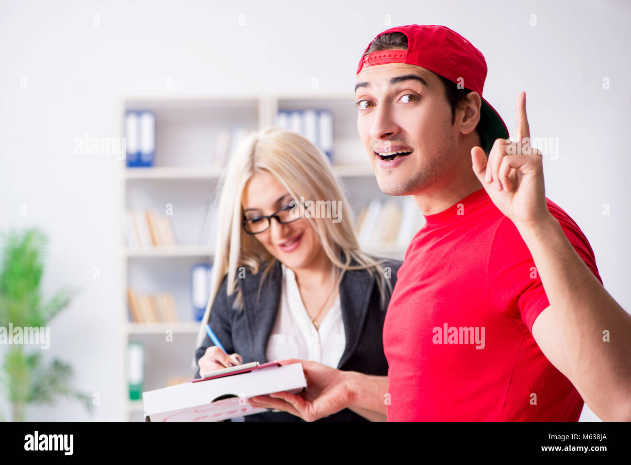 Woman businesswoman receiving mail parcel from courier Stock Photo - Alamy