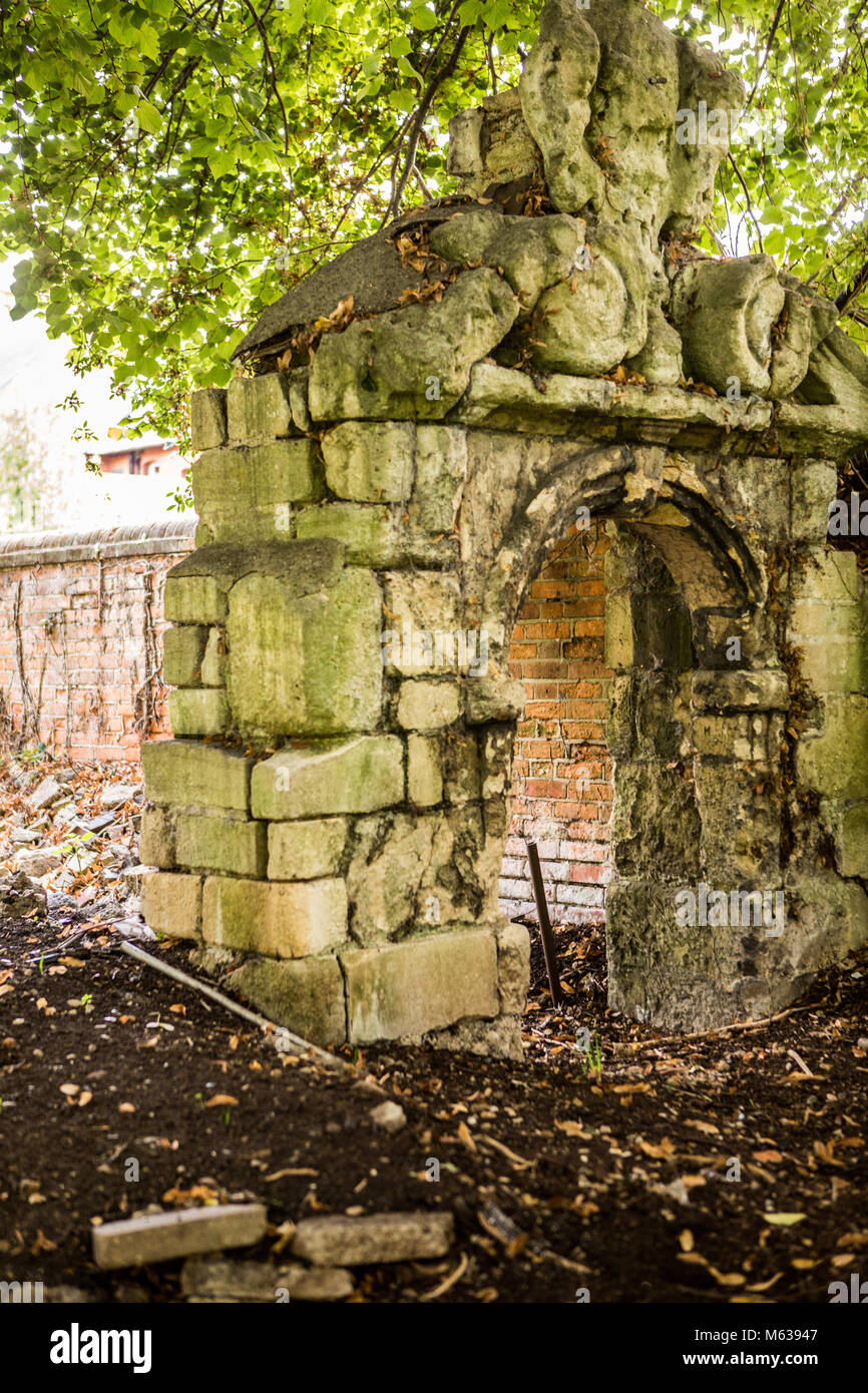 Old stone archway ruin in British garden kept as feature Stock Photo ...