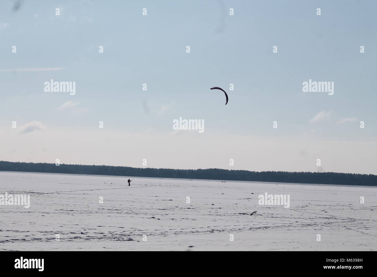 brave man under parachute on snowboard training on the surface of ...