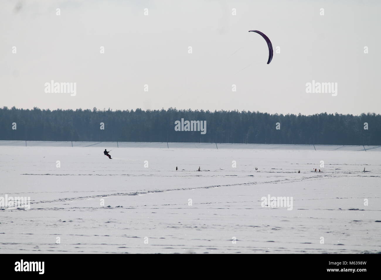 brave man under parachute on snowboard training on the surface of ...