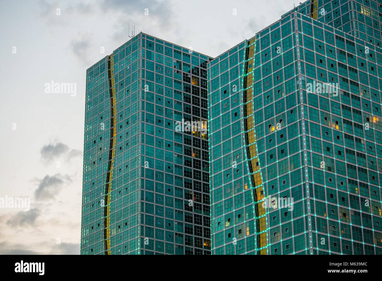 Blue and yellow glass buildings at sunset with plain sky Stock Photo ...