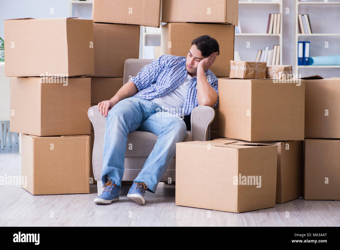 Young man moving in to new house with boxes Stock Photo - Alamy