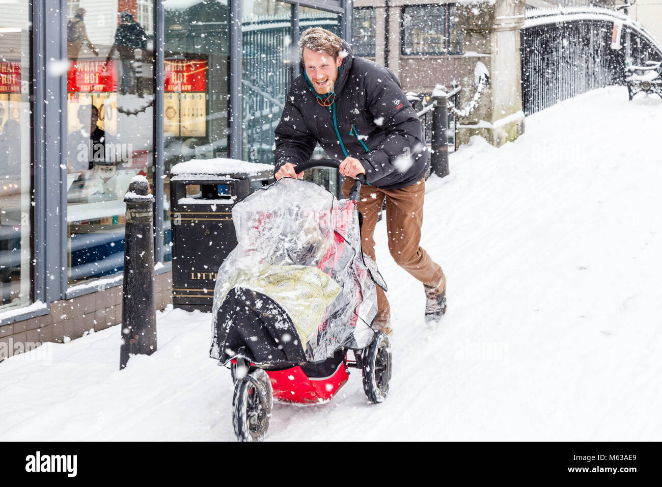 A local man pushing a pushchair down a slope, Lewes, Sussex, UK Stock ...