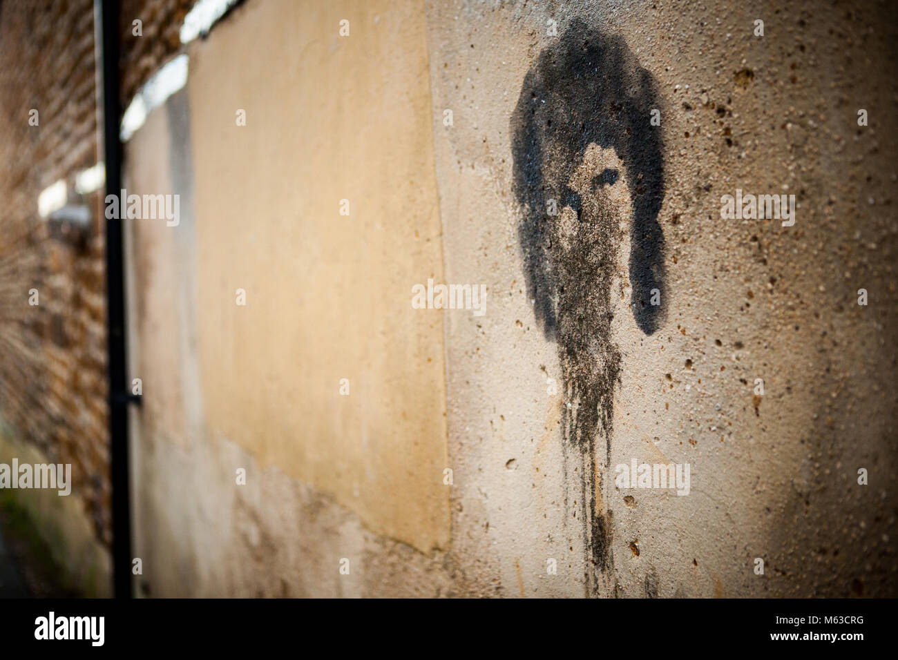 Face stay painted onto wall, only graffiti on lean wall Stock Photo - Alamy