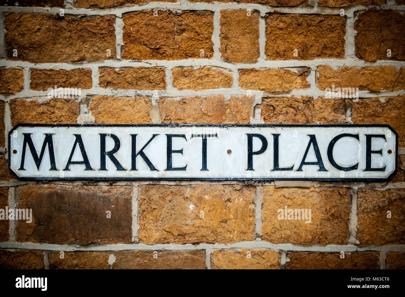 Close up of traditional British iron street sign reading market place ...
