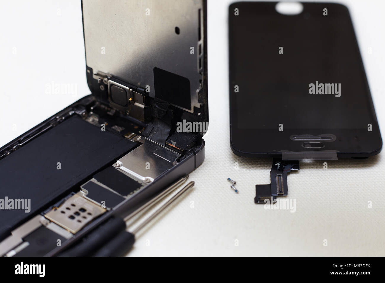Close-up photos showing process of mobile phone repair, changing the ...