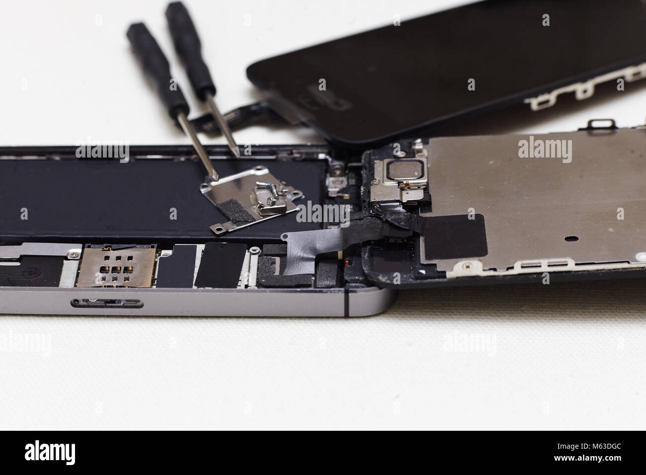 Close-up photos showing process of mobile phone repair, changing the ...