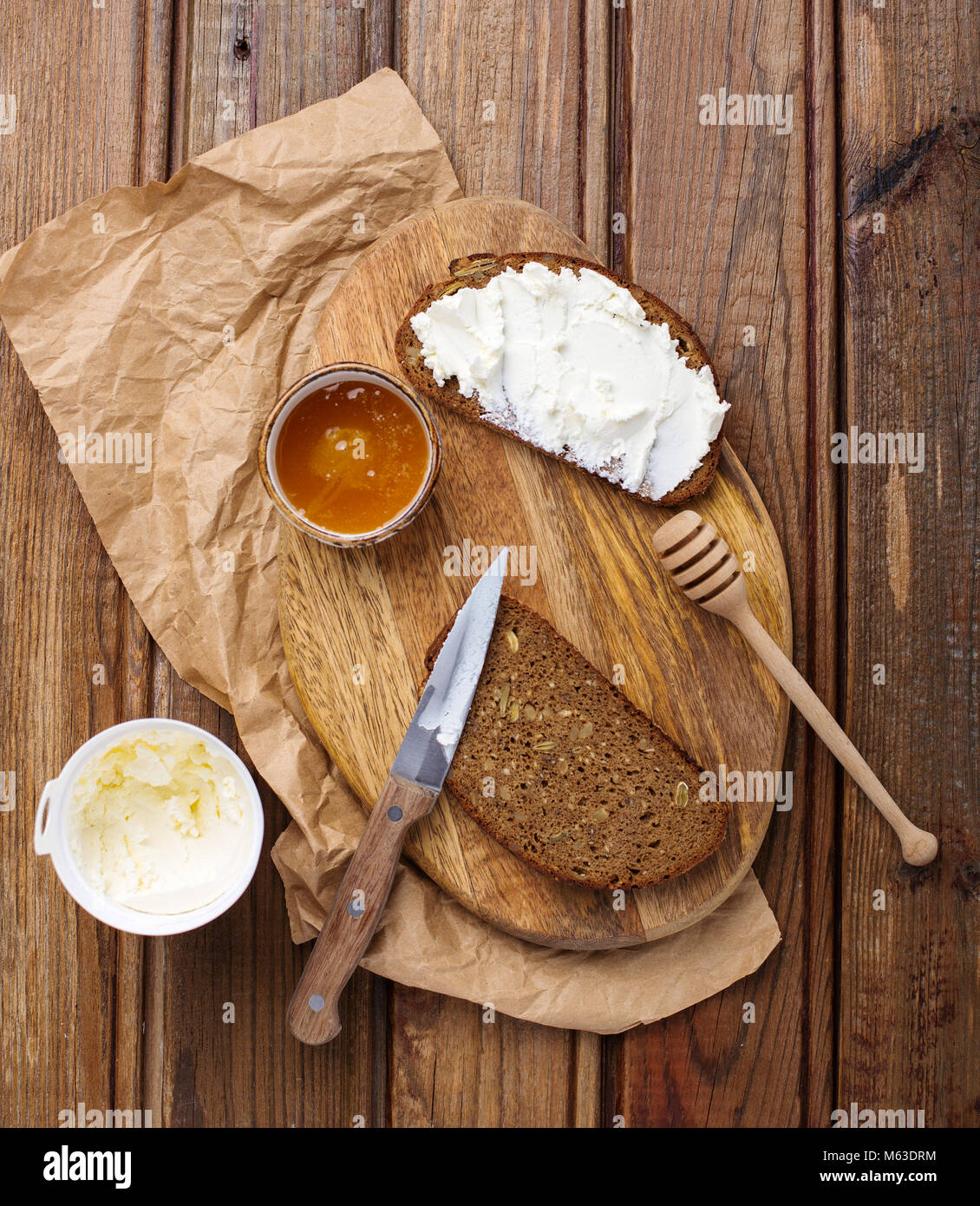 Pieces of rye bread with cream cheese and some honey Stock Photo - Alamy