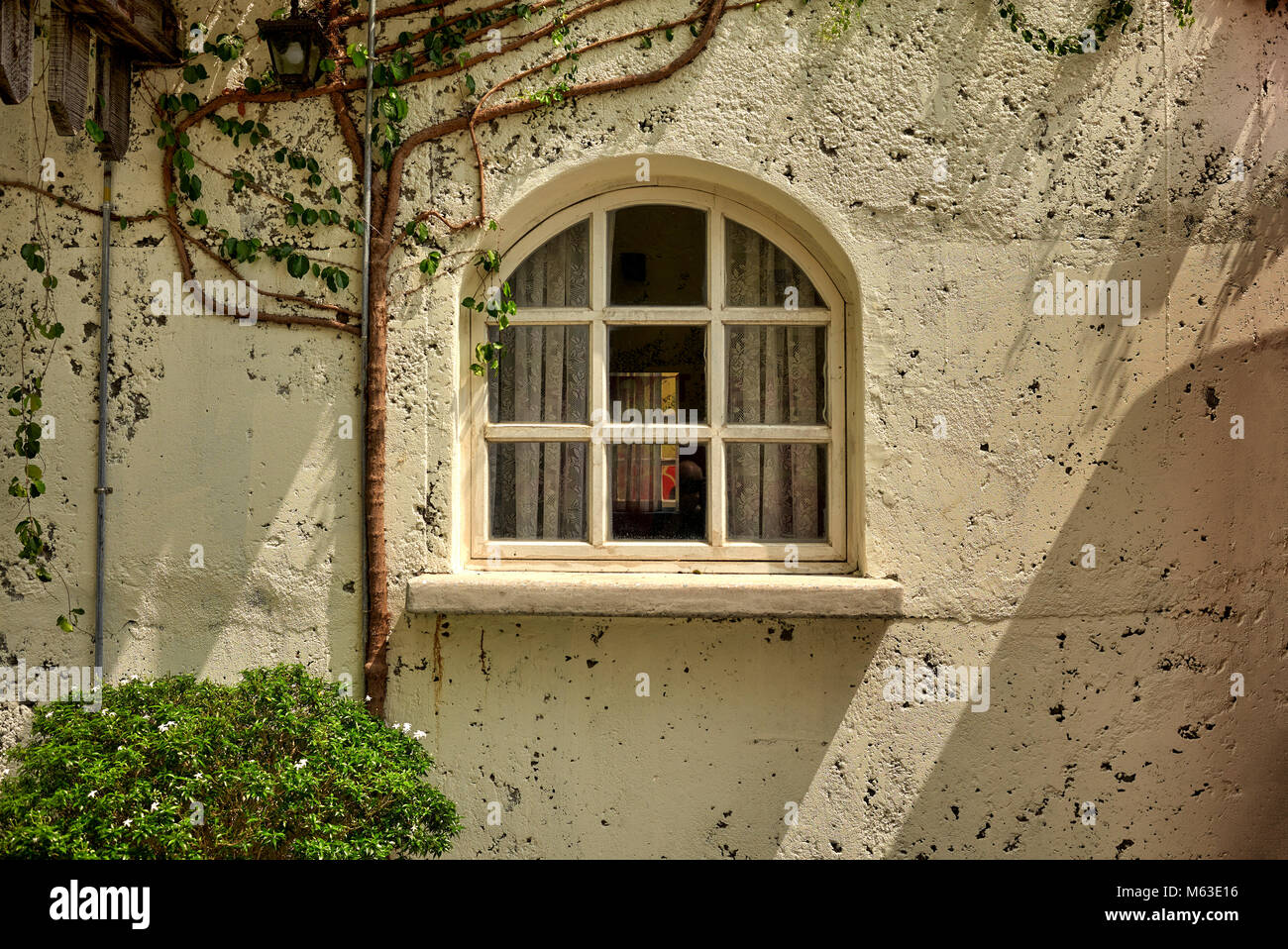 Arched window of a stone built cottage home. Traditional cottage ...
