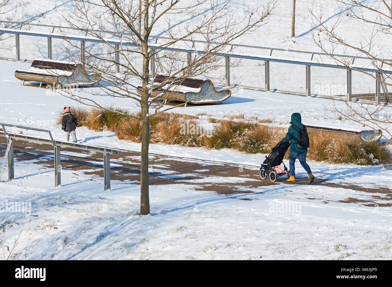Mother and child enjoy walk in snow at the Queen Elizabeth Olympic Park ...