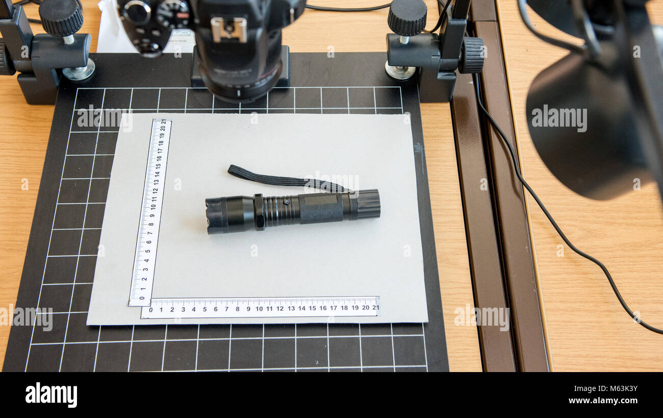 28 February 2018, Germany, Hamburg: A taser disguised as torch lies on ...