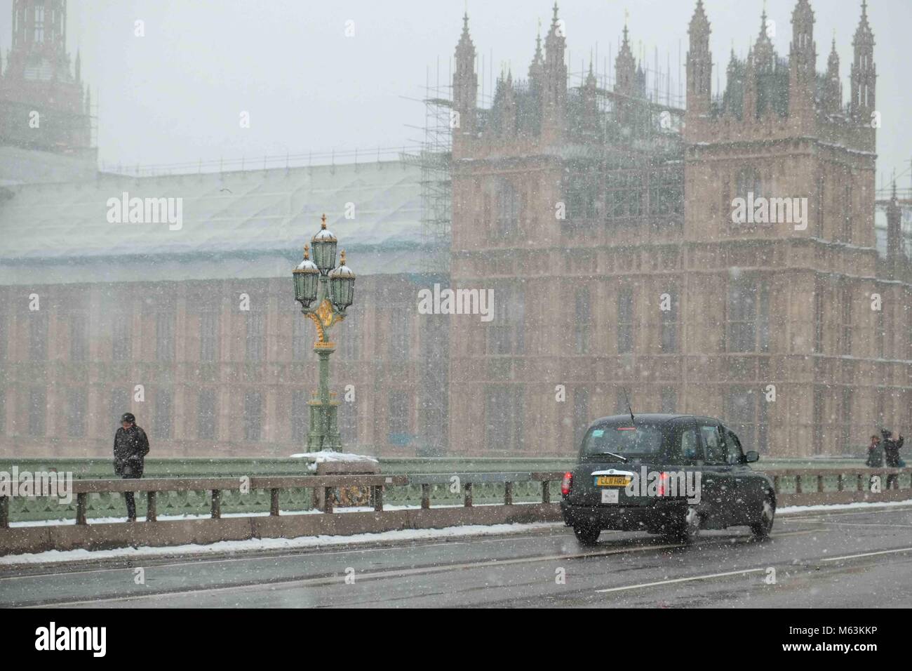 London, UK. 28th Feb, 2018. UK Weather: Pedestrians cross Westminster ...