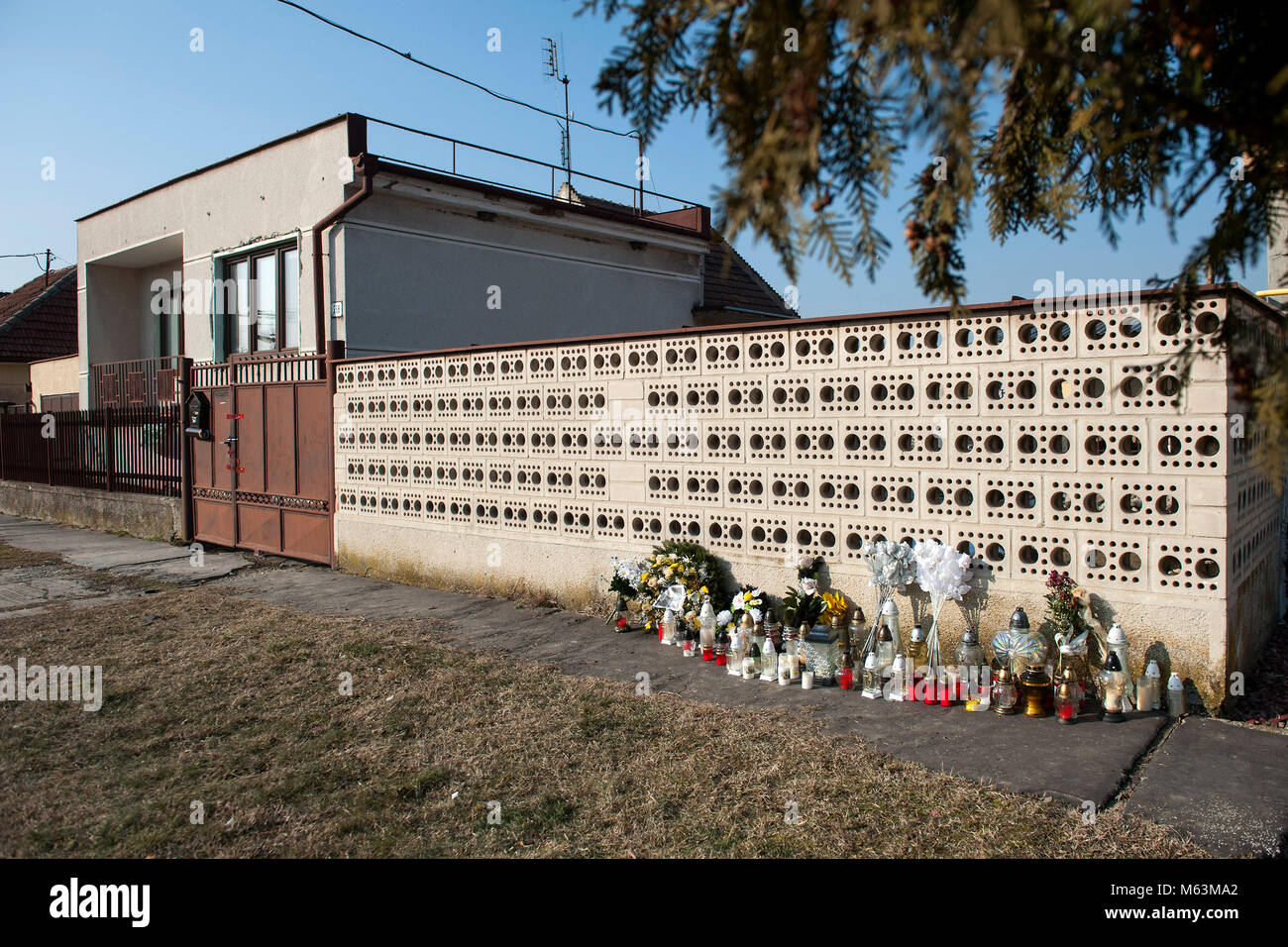 Velka Maca, Slovakia. 28th Feb, 2018. Flowers and candles are seen in ...