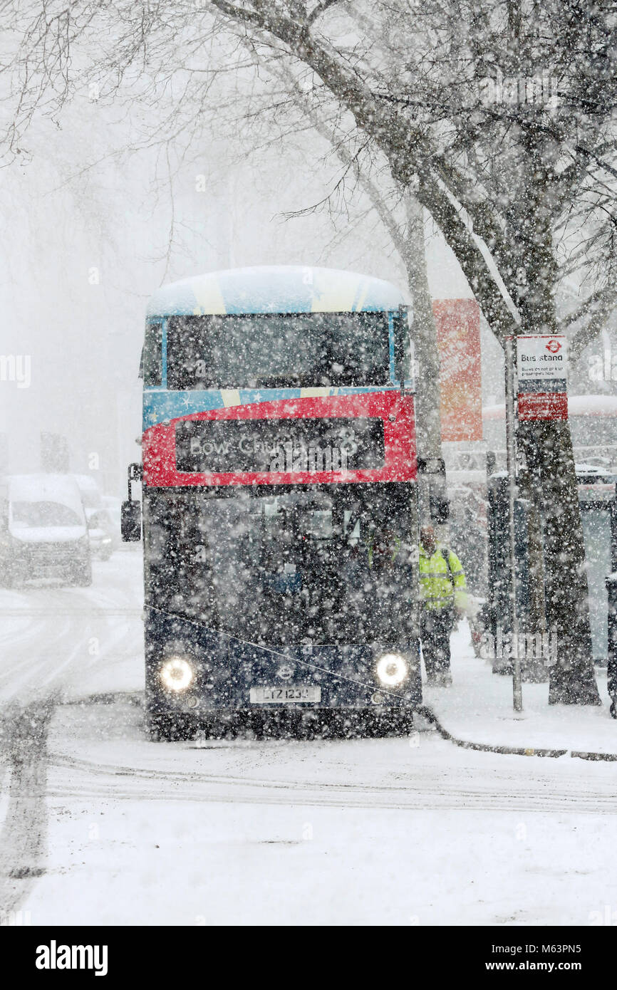 London, UK. 28th February, 2018. Snow sweeps London. A double decker ...