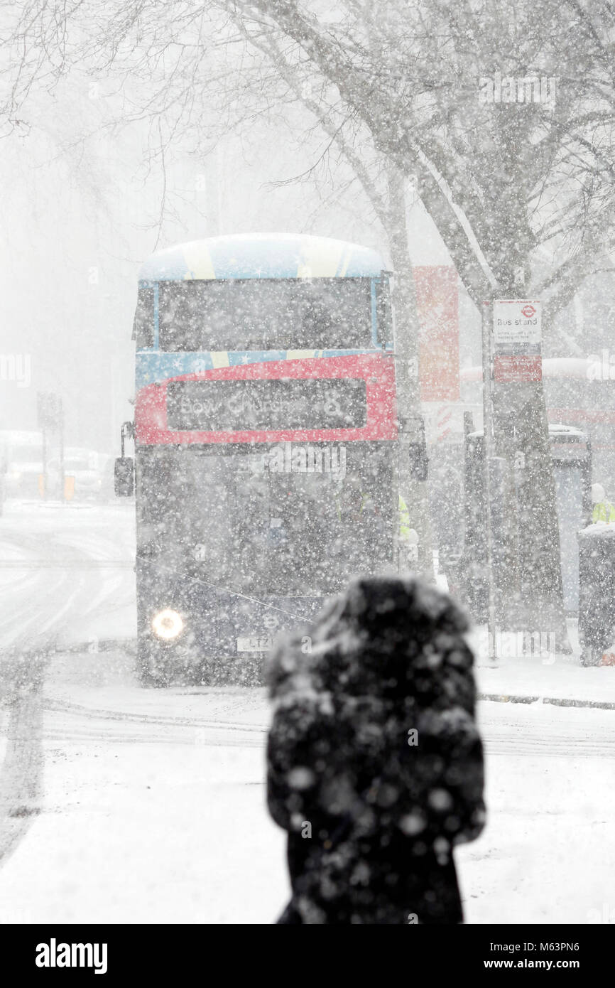 London, UK. 28th February, 2018. Snow sweeps London. A double decker ...