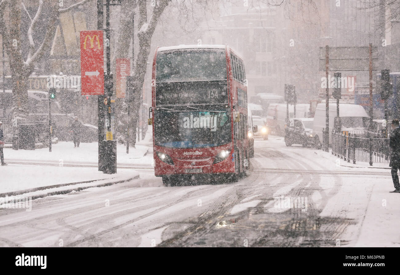 London, UK. 28th February, 2018. Snow sweeps London. A double decker ...