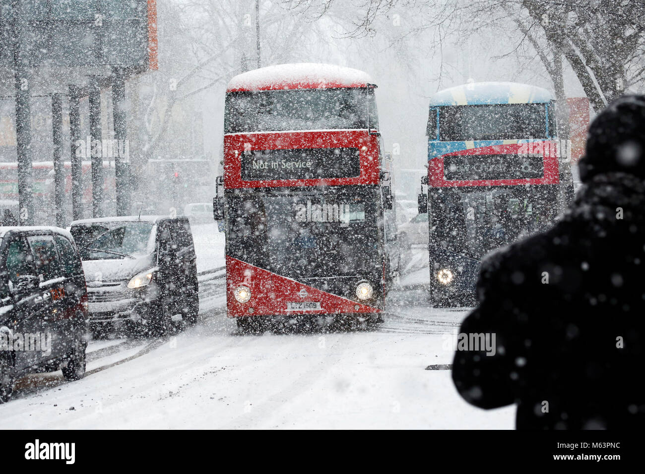 London, UK. 28th February, 2018. Snow sweeps London. A double decker ...