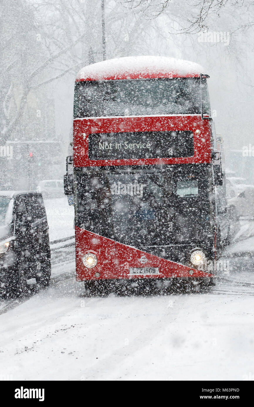 London, UK. 28th February, 2018. Snow sweeps London. A double decker ...