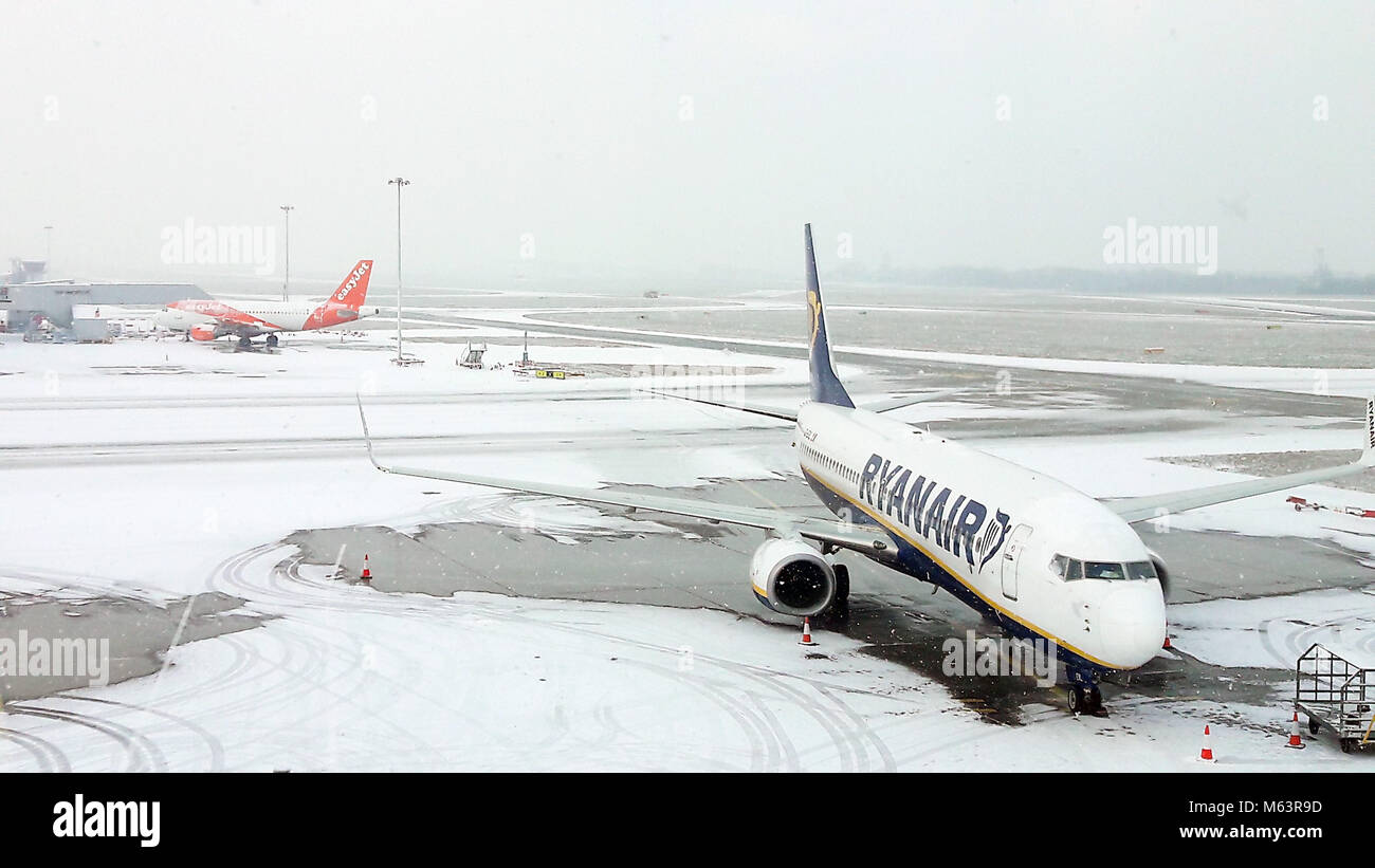 London, UK. Ryanair planes awaiting boarding and being cleaned of ice ...
