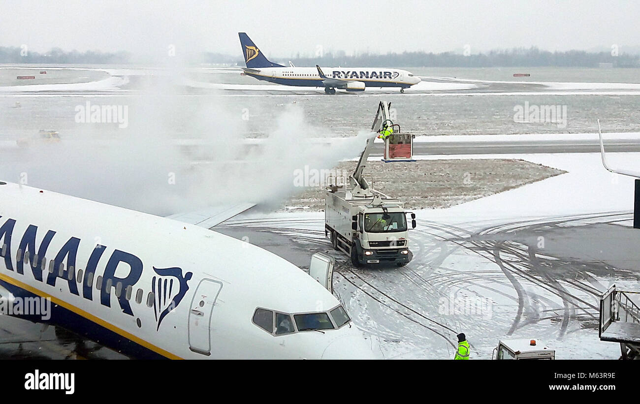 London, UK. Ryanair planes awaiting boarding and being cleaned of ice ...