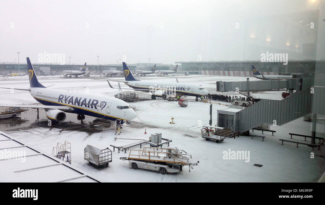 London, UK. Ryanair planes awaiting boarding and being cleaned of ice ...