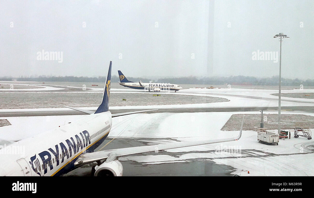 London, UK. Ryanair planes awaiting boarding and being cleaned of ice ...