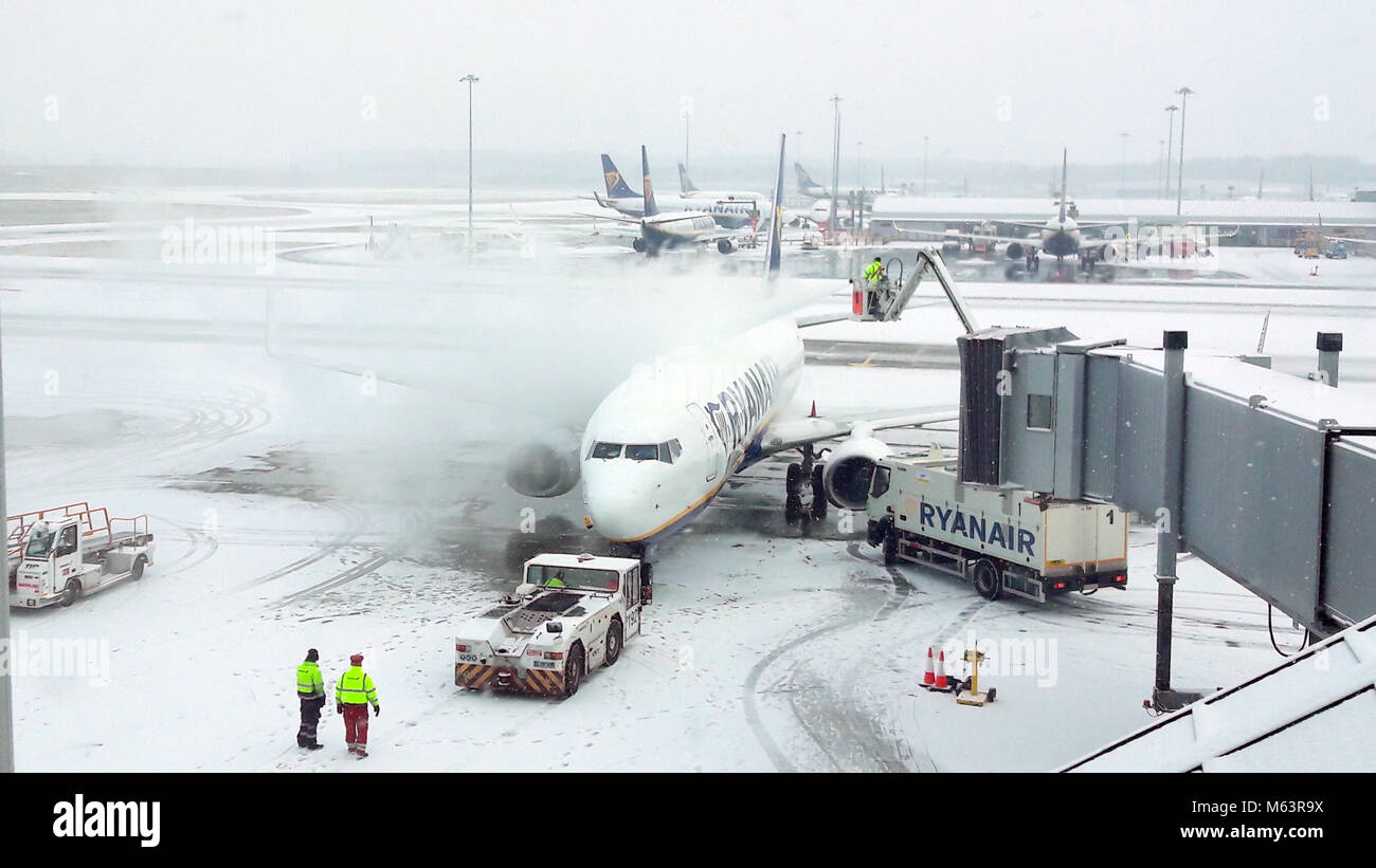 London, UK. Ryanair planes awaiting boarding and being cleaned of ice ...