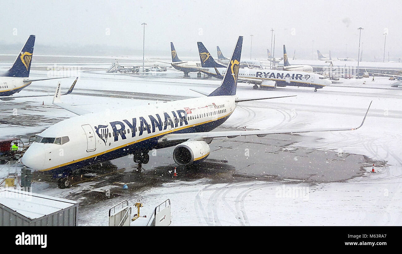 London, UK. Ryanair planes awaiting boarding and being cleaned of ice ...