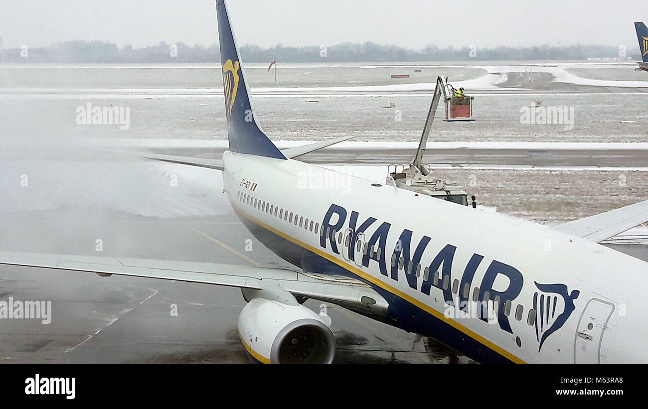 London, UK. Ryanair planes awaiting boarding and being cleaned of ice ...