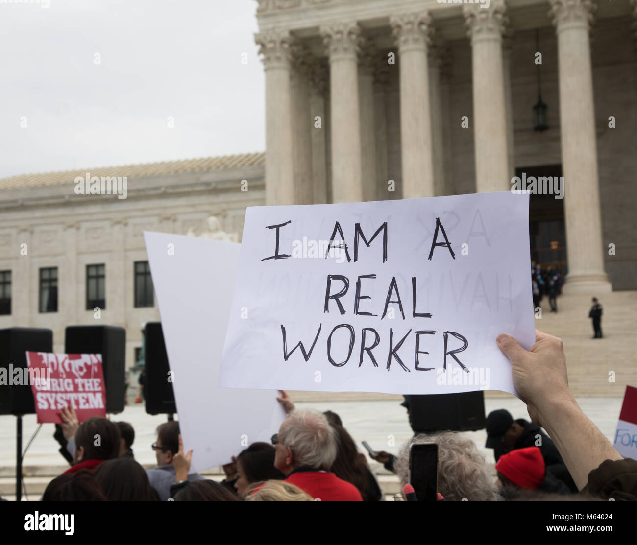 "I am a real worker" reads the sign. Demonstrators gather as the U.S ...