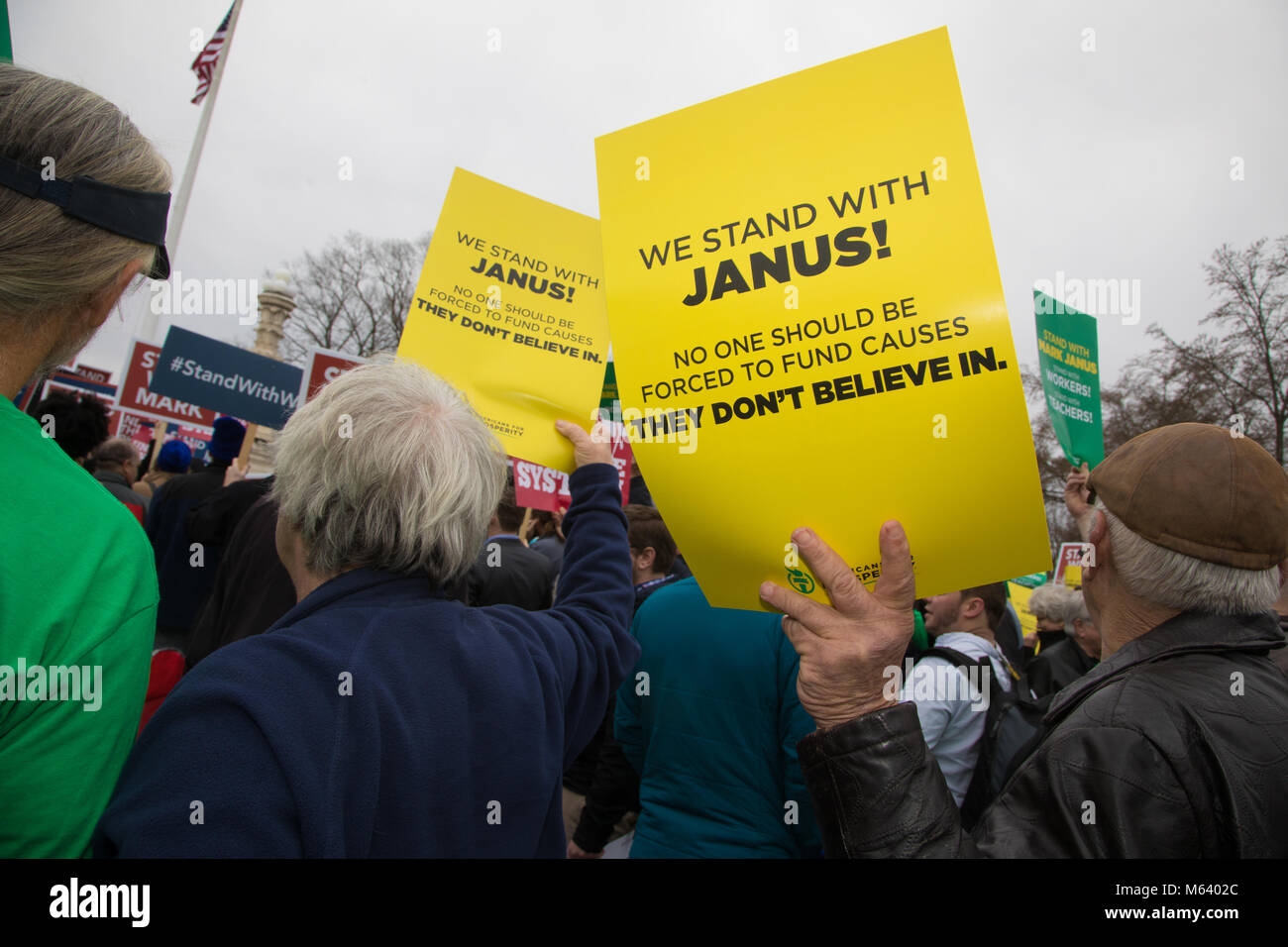 "We Stand with Janus" reads the sign carried by members of American's ...
