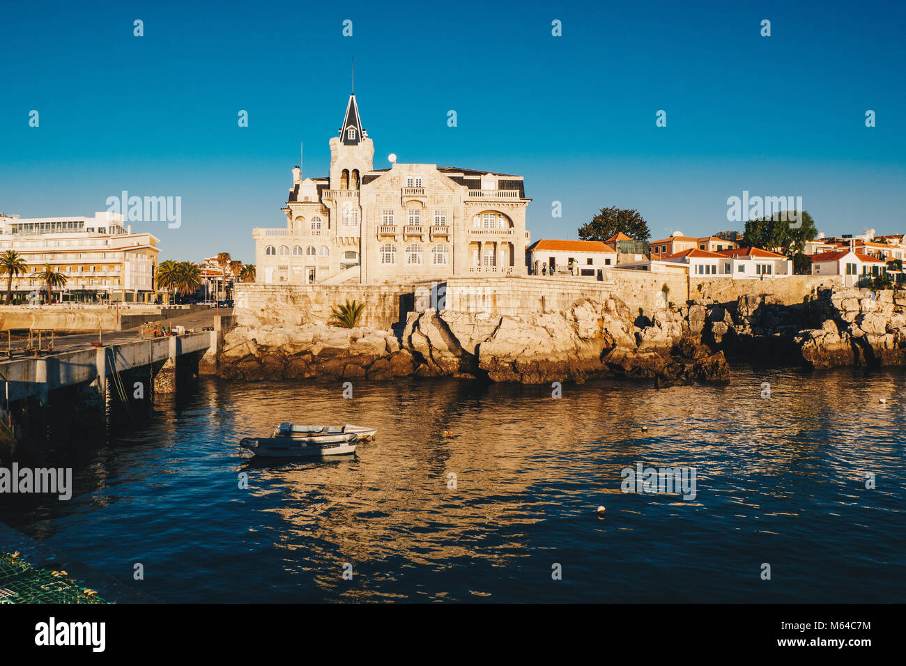 Sea view of Cascais city in Portugal at sunrise with fishing boats ...