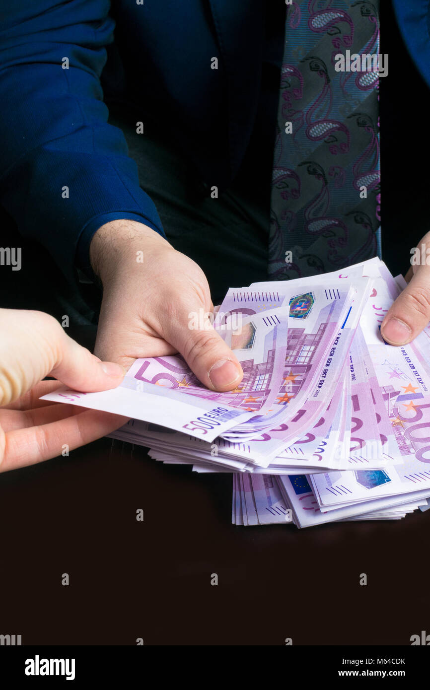 Man in Men's Suits.Bribe and corruption with euro banknotes Stock Photo ...