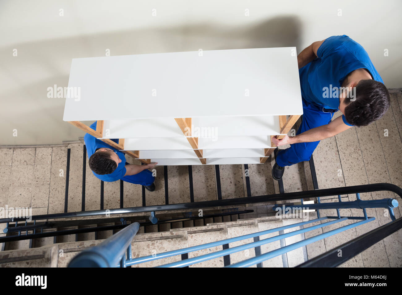 Two men carrying furniture hi-res stock photography and images - Alamy