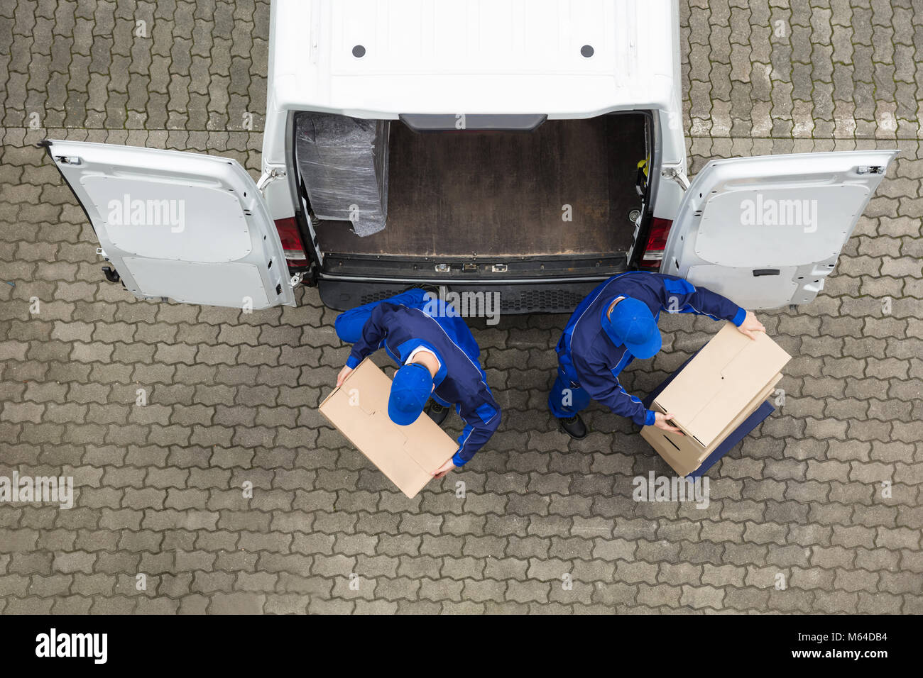 Workers teamwork working together men unloading truck hi-res stock ...