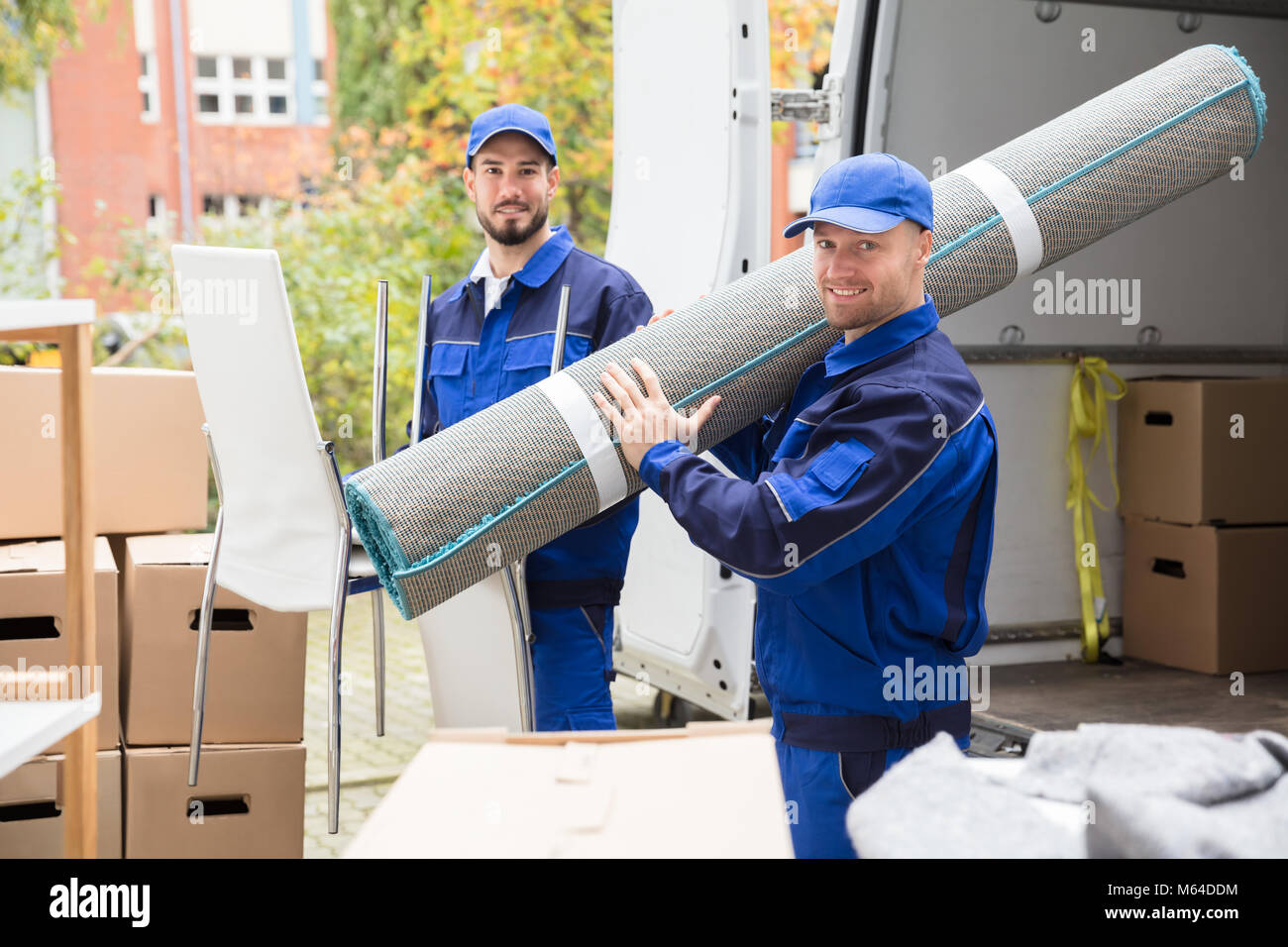 Two men carrying carpet hi-res stock photography and images - Alamy