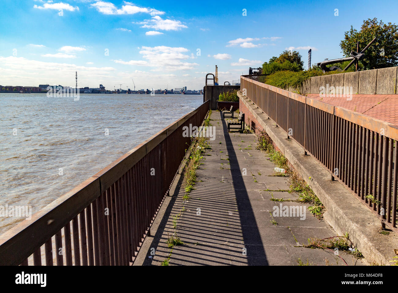 River Thames flood defences and footpath at North Woolwich, London in ...