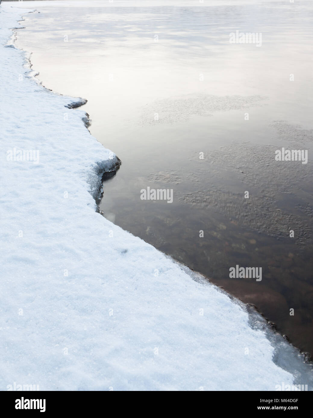 Partially frozen lake shore Stock Photo - Alamy