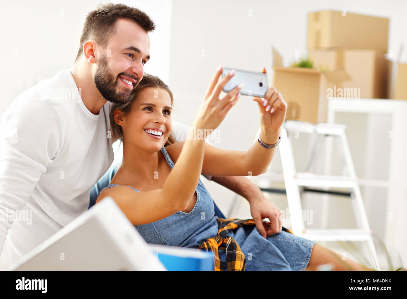 Happy adult couple moving out or in to new home Stock Photo - Alamy
