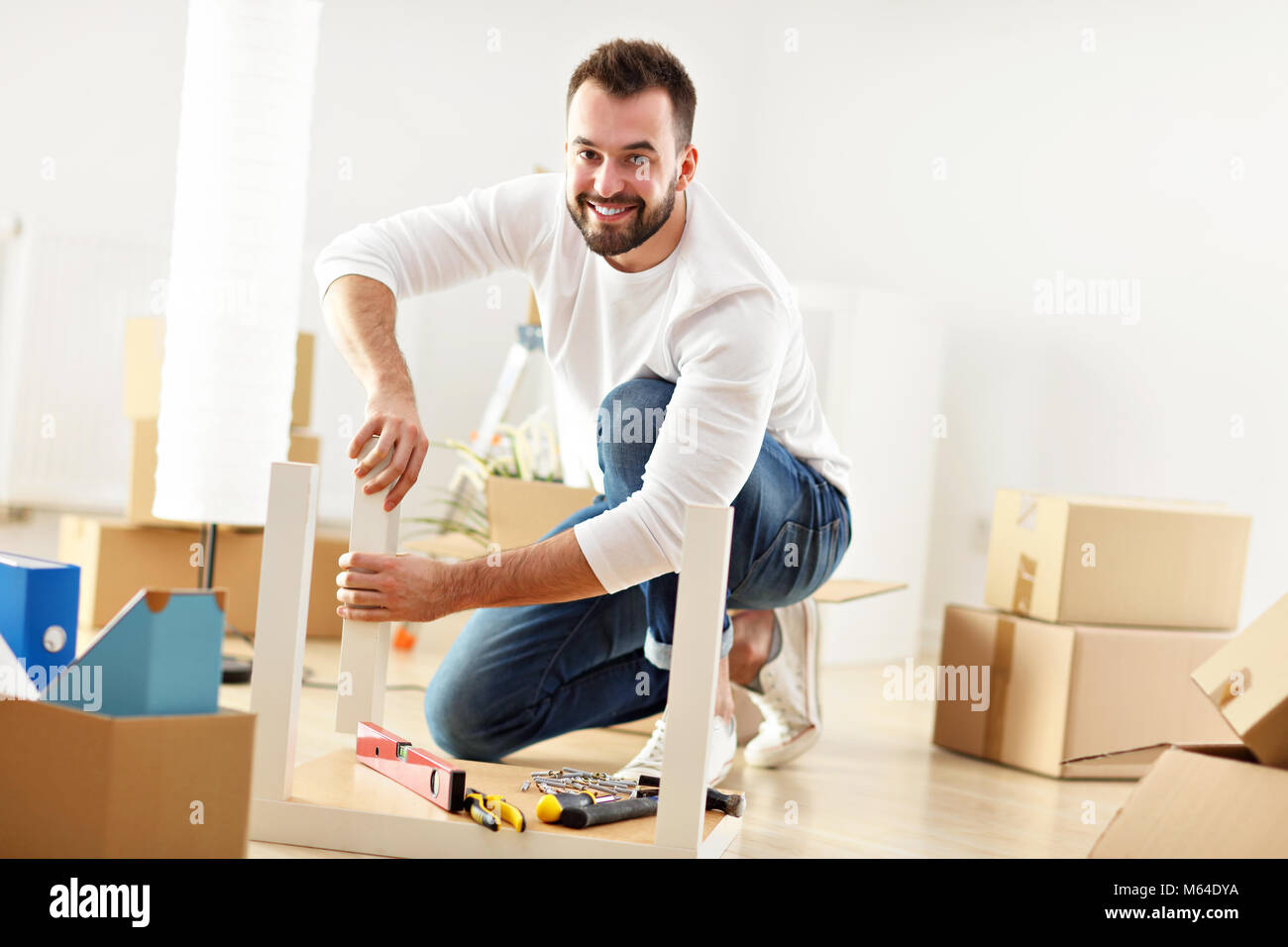 Happy adult couple moving out or in to new home Stock Photo - Alamy