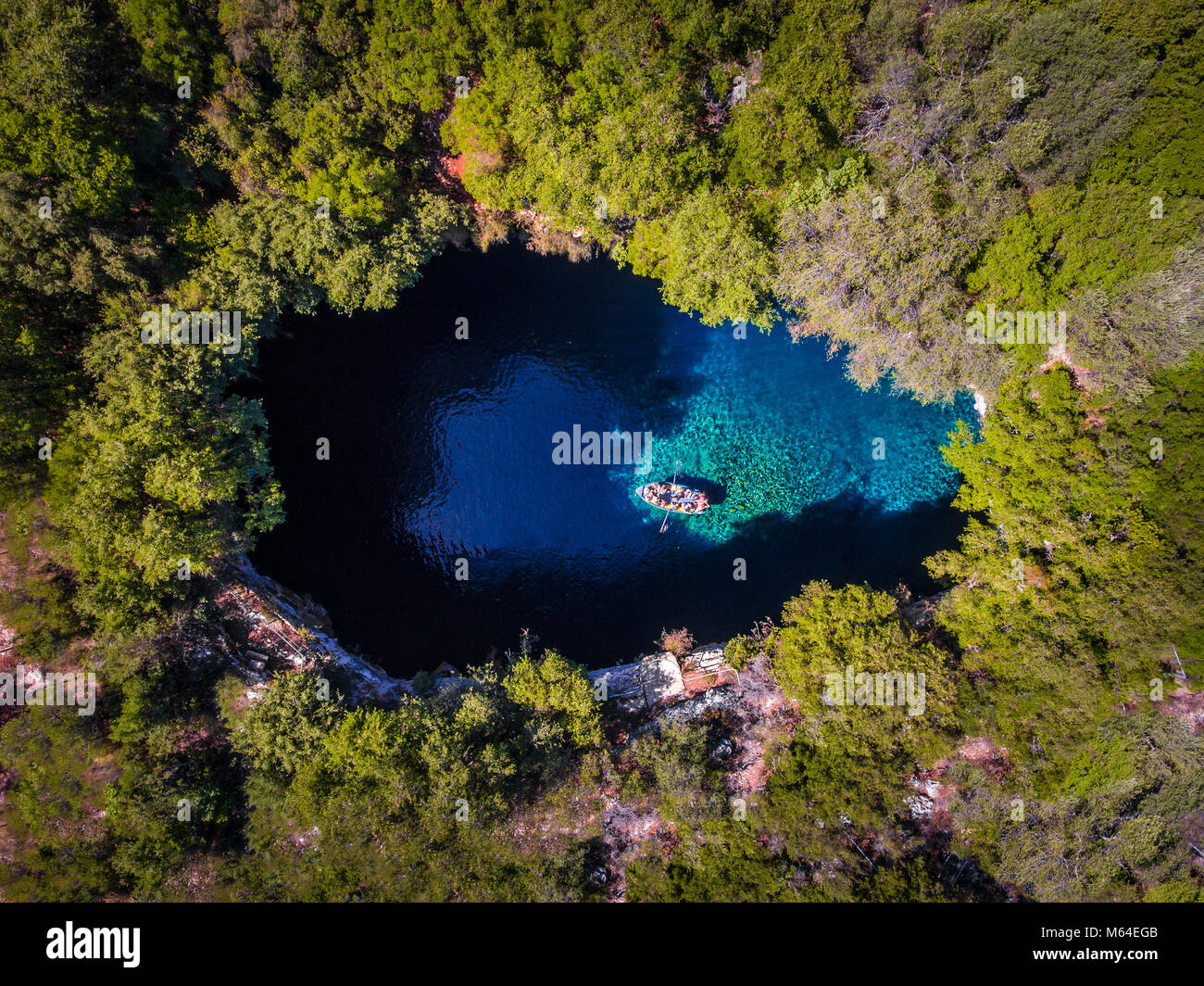 Melissani Cave Kefalonia viewed from above with tourists entering the ...