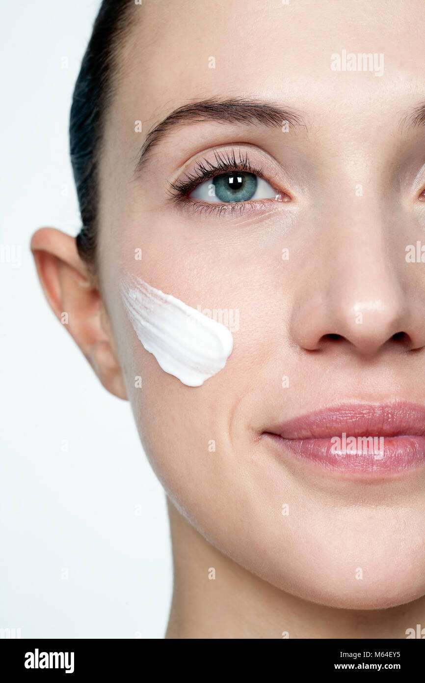 Cropped woman's face with cream Stock Photo - Alamy