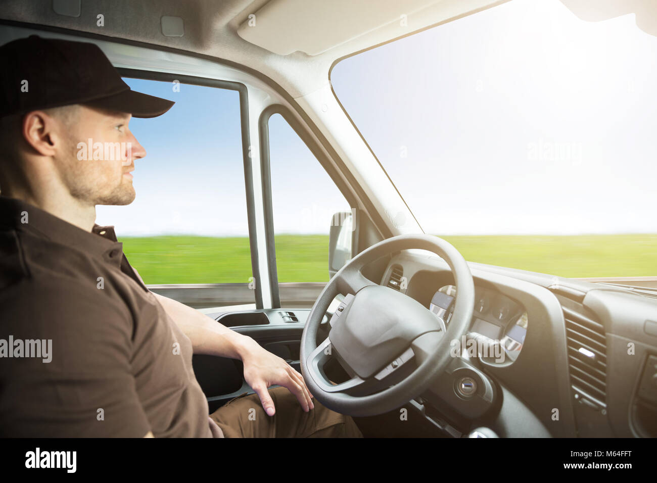 Portrait Of A Young Delivery Man Sitting Inside Self Driving Van Stock ...