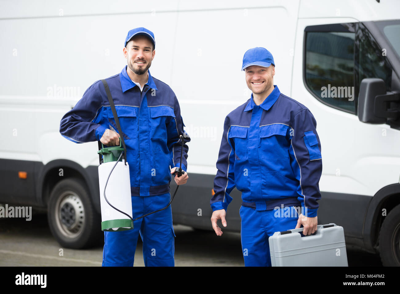 Portrait Of Two Happy Male Pest Control Workers With Toolbox Stock ...