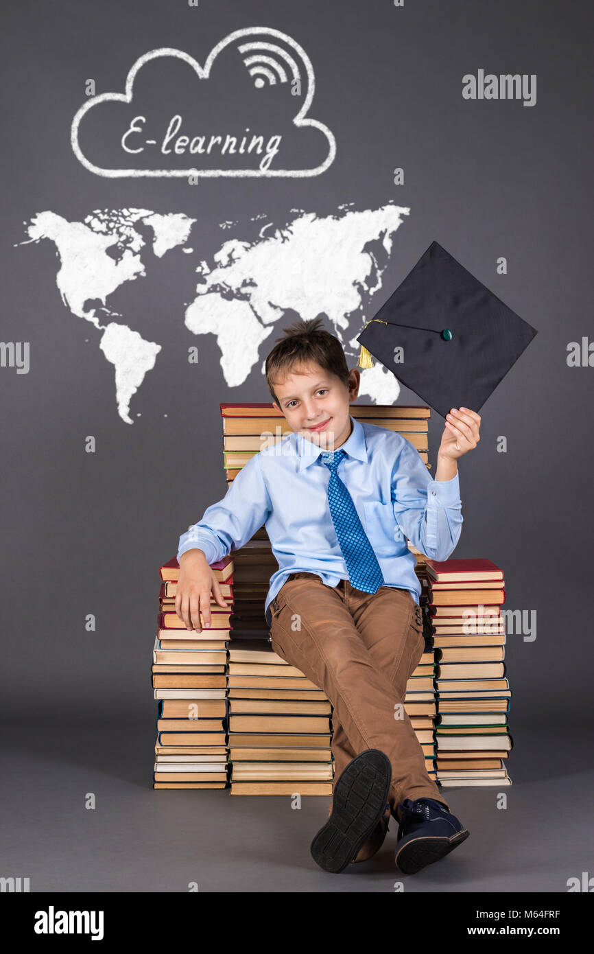 E-Learning education concept. Happy boy getting knowledge remotely via ...
