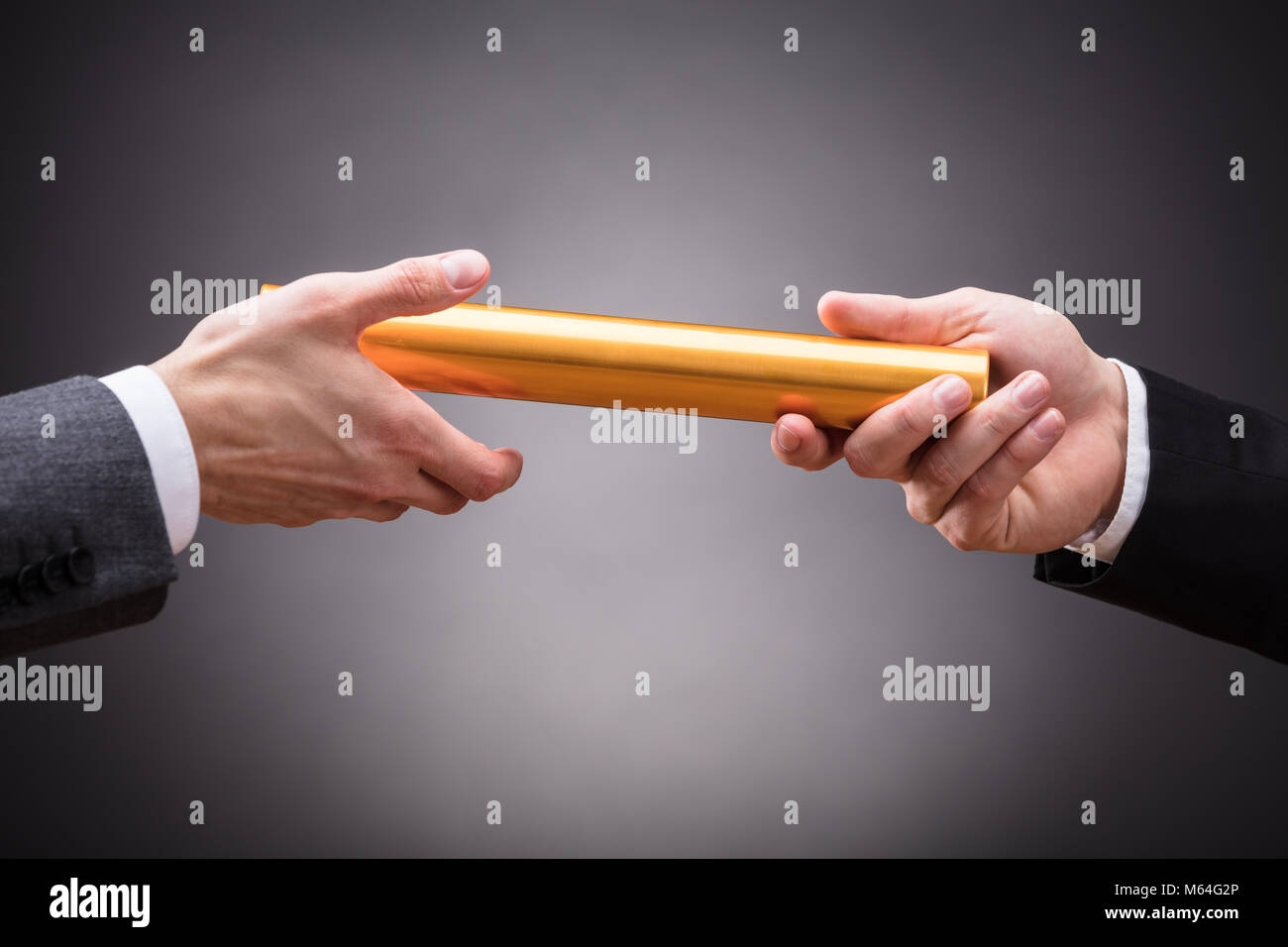 Hand passing golden baton hi-res stock photography and images - Alamy