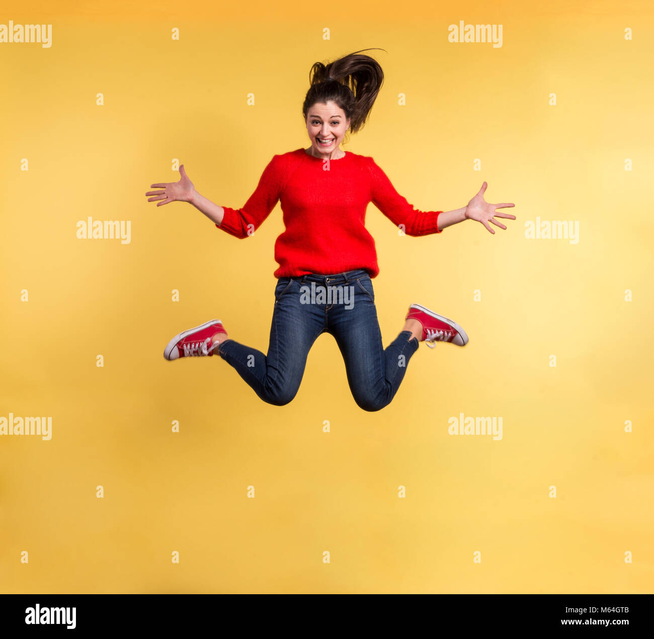 Young beautiful woman in studio, jumping Stock Photo - Alamy